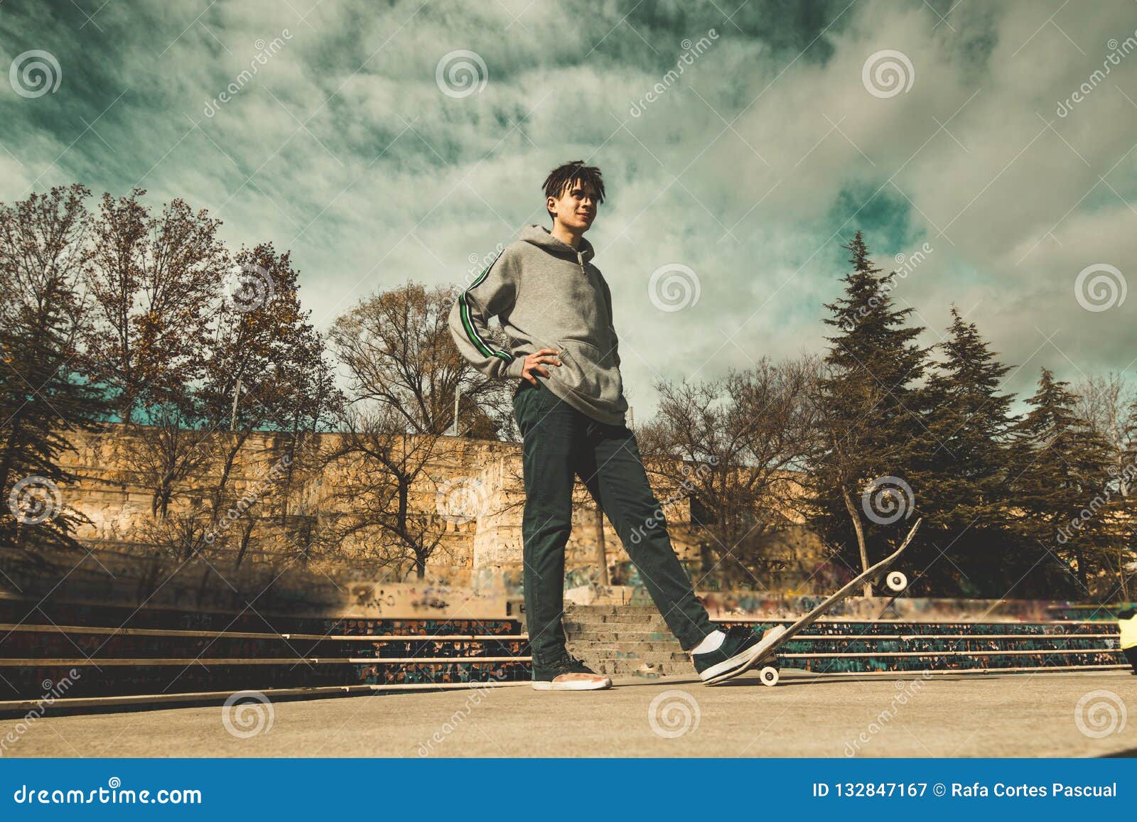 Guy Skateboarder Riding a Skateboard on a Skatepark. Young Man Jumping ...