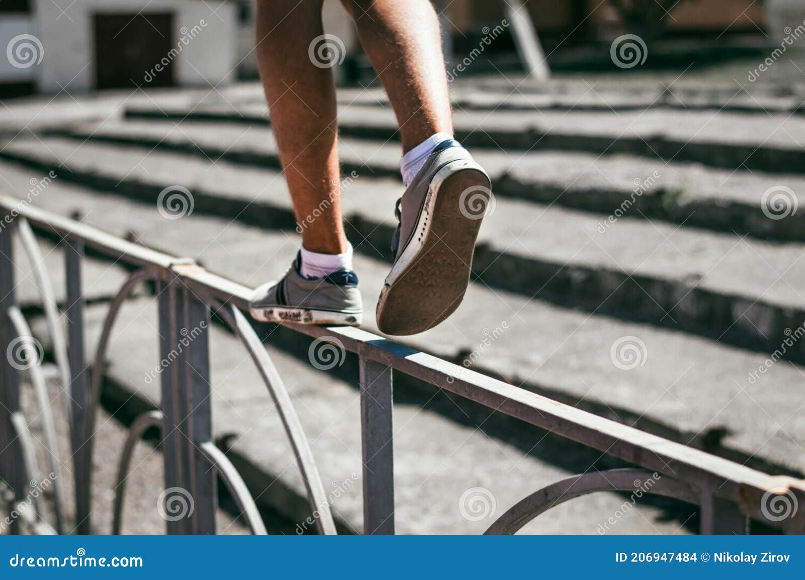 Guy in the Sneakers is Walking on the Fence. Climb Over the Fence Stock ...
