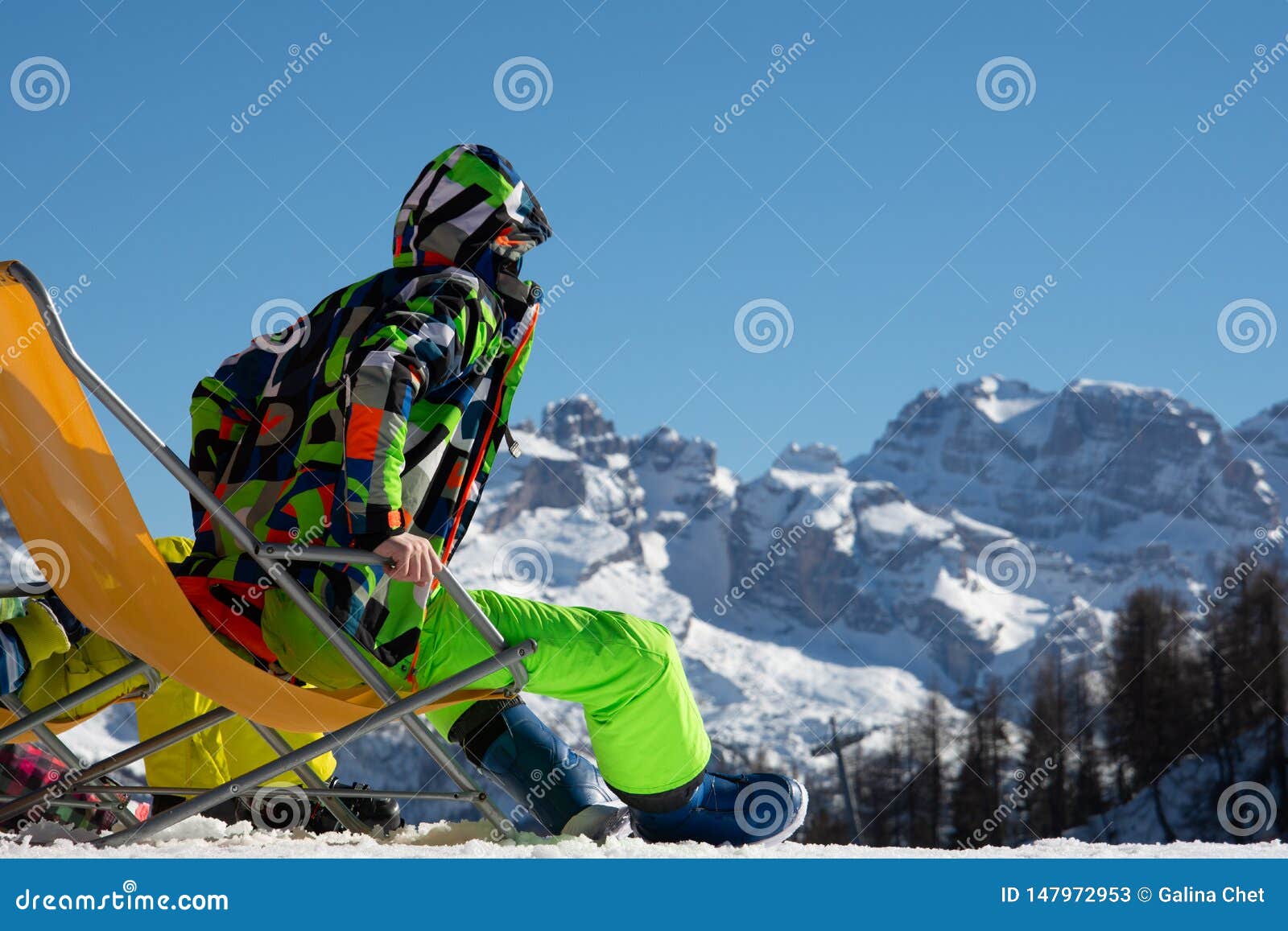 The Guy the Snowboarder Sits on a Chaise Lounge on a Ski Slope Stock ...