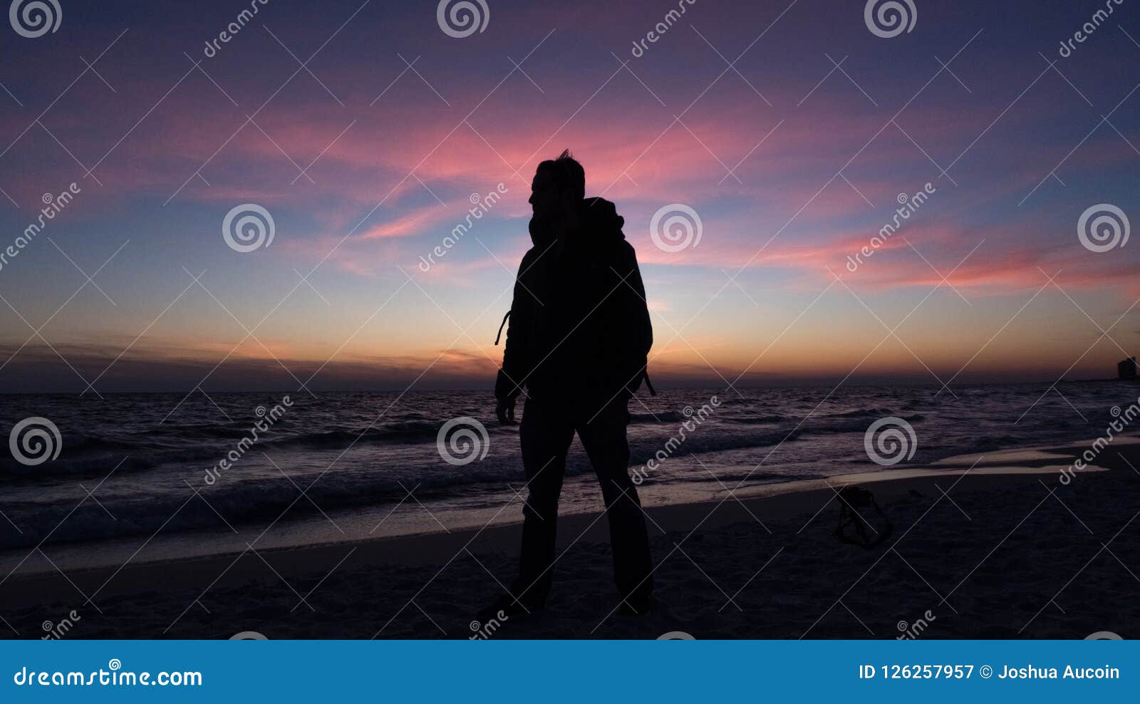 Guy Stands in Front of Dramatic Sunset Over the Ocean Stock Image ...