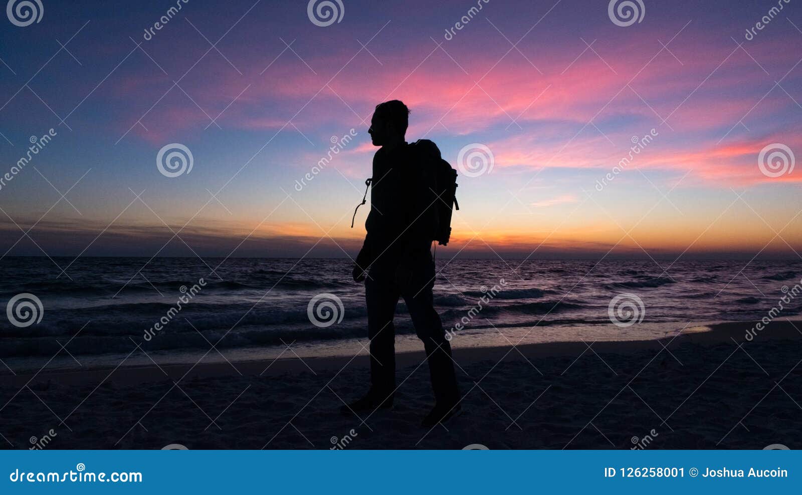 Guy Stands in Front of Dramatic Sunset Over the Ocean Stock Image ...