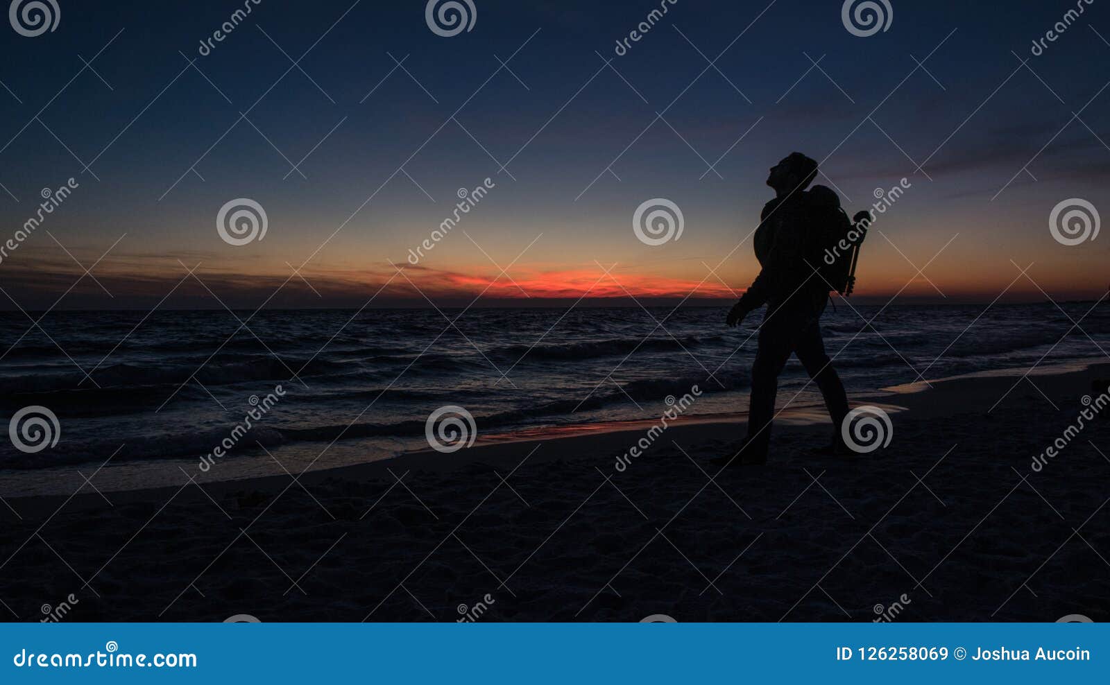 Guy Stands in Front of Dramatic Sunset Over the Ocean Stock Image ...
