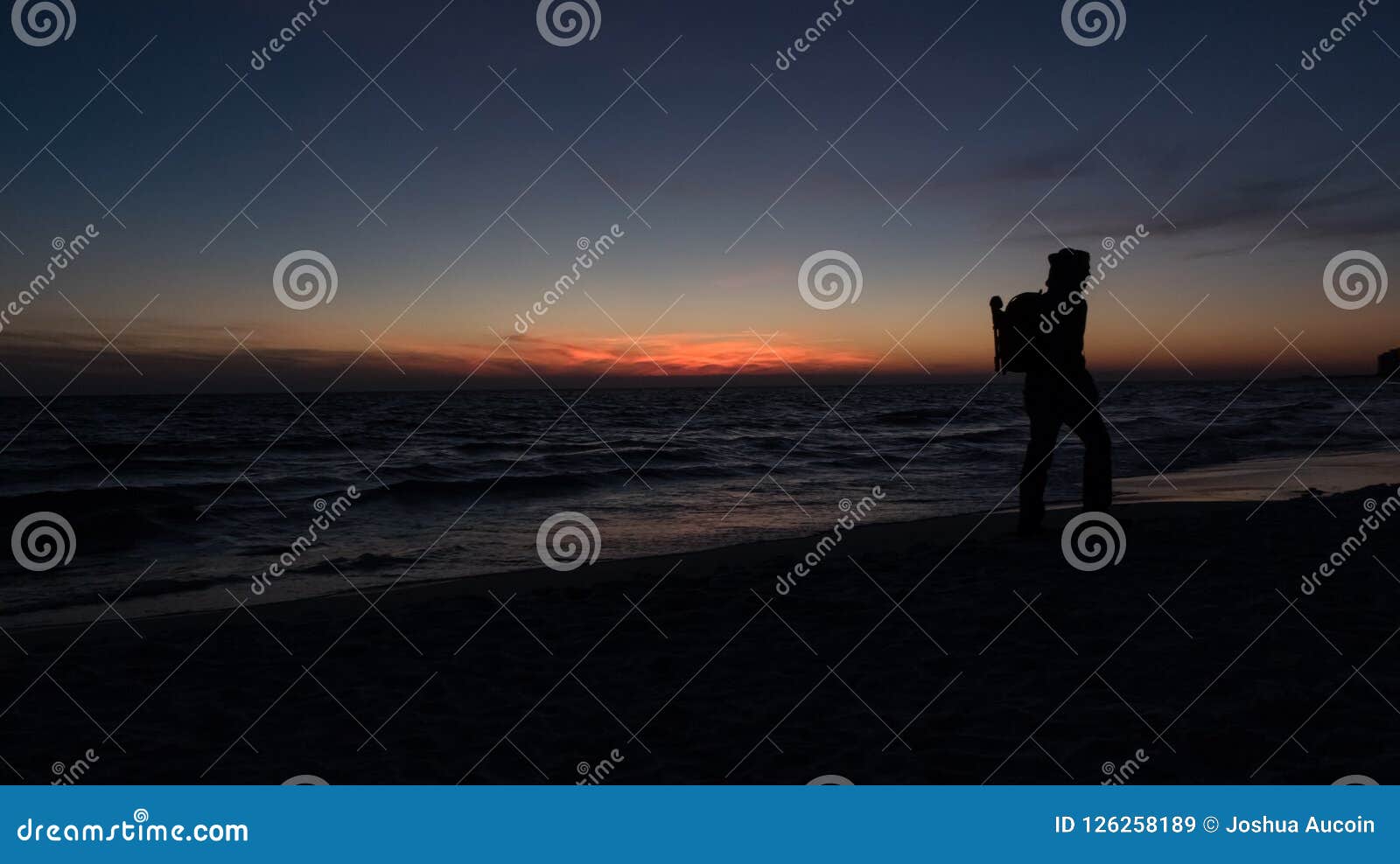 Guy Stands in Front of Dramatic Sunset Over the Ocean Stock Image ...