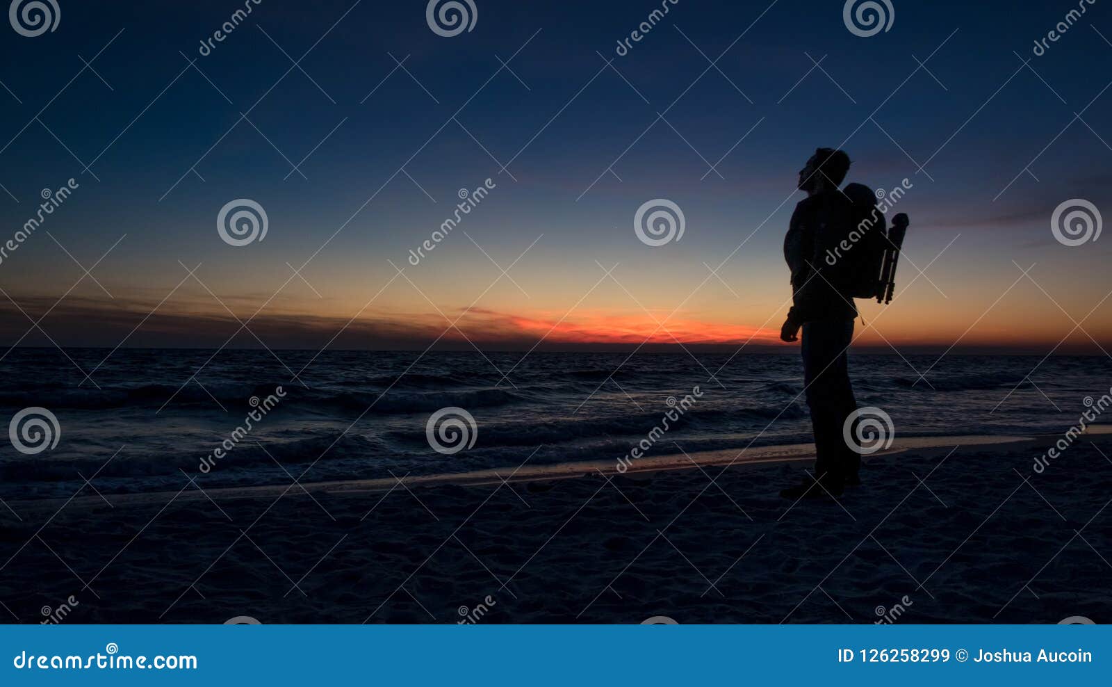 Guy Stands in Front of Dramatic Sunset Over the Ocean Stock Image ...