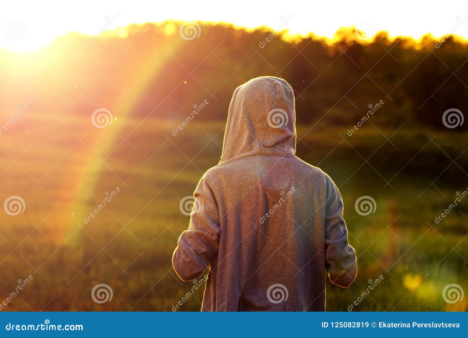 The Guy Stands with His Back Looking at the Sun in the Evening Stock ...