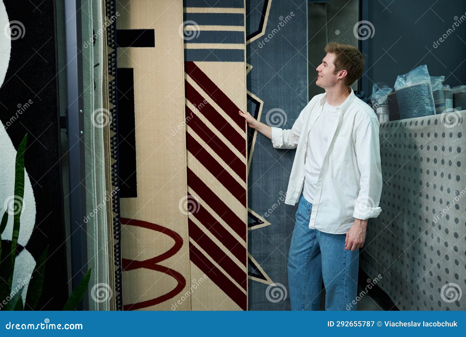 Guy Stands at a Rack with Carpet Samples Stock Image - Image of ...