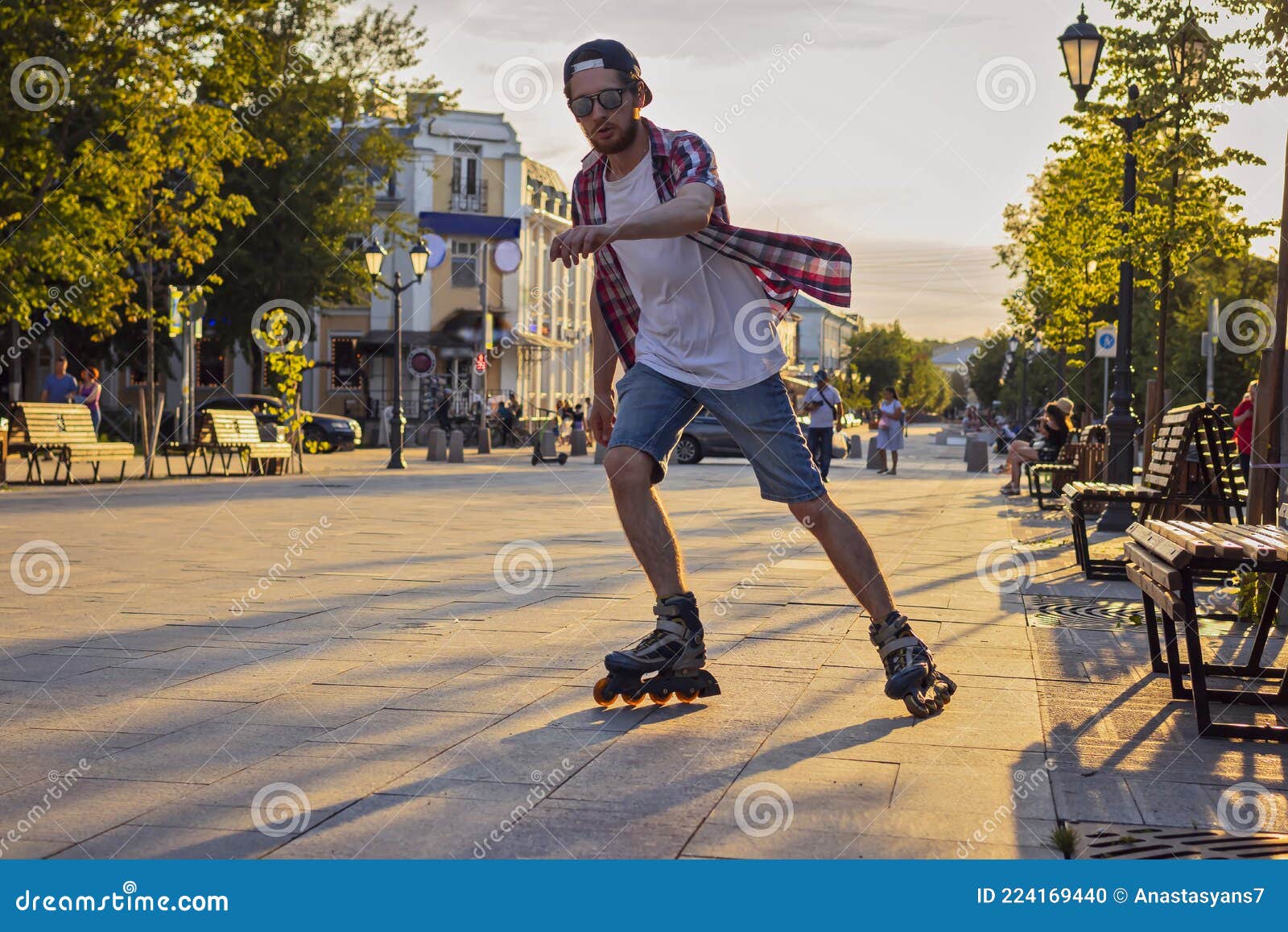 A Guy on the Street is Roller Skating at Sunset 2 Stock Photo - Image ...