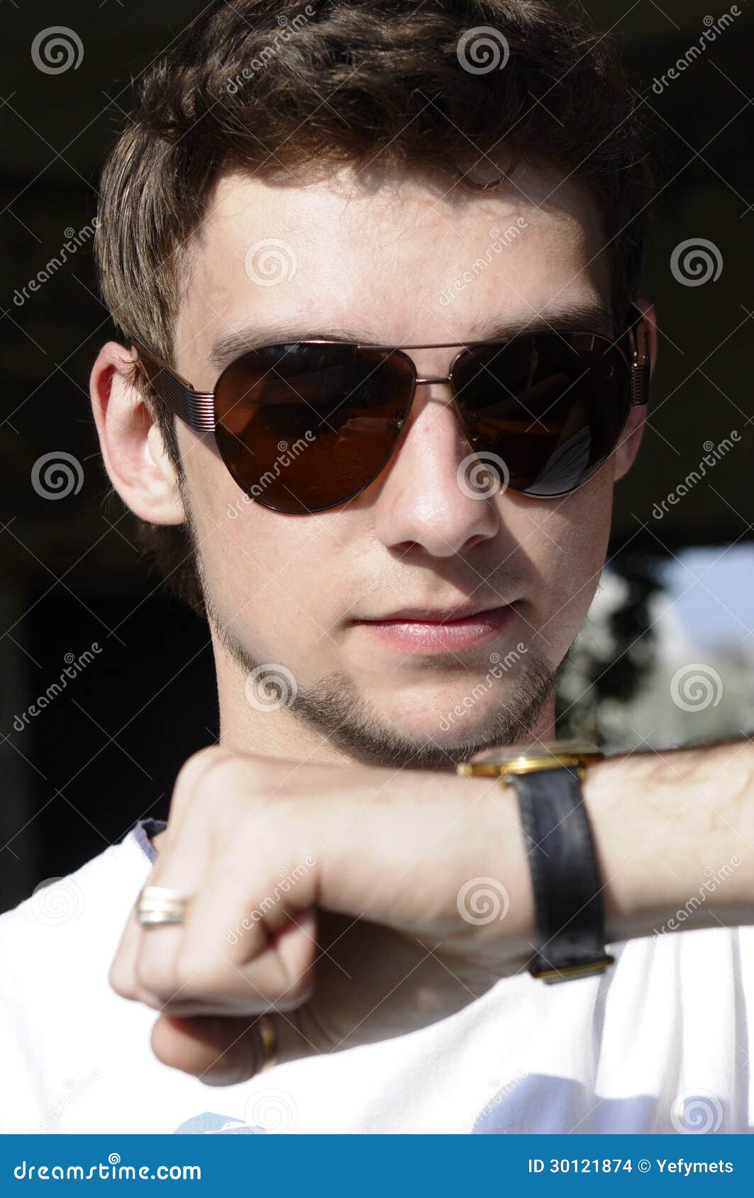 The guy looks at his watch stock photo. Image of sunglasses - 30121874