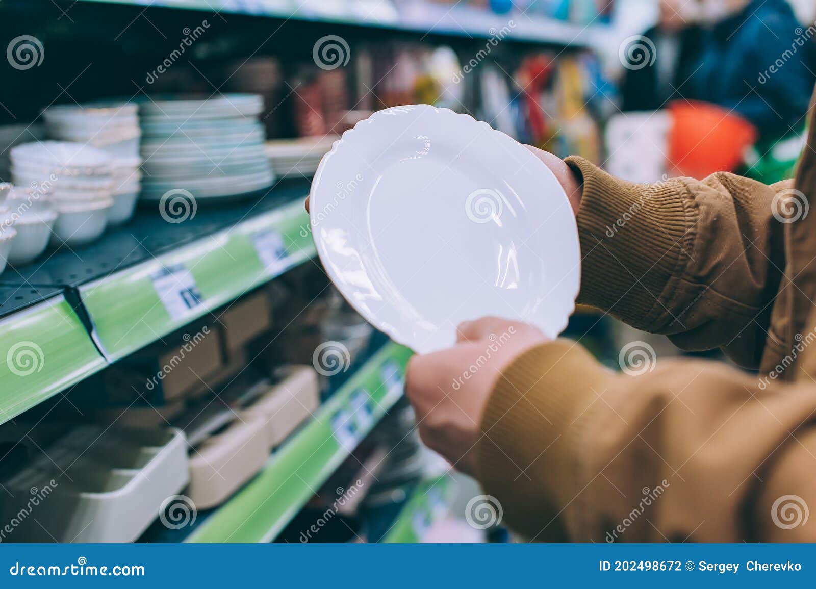 The Guy in the Supermarket is Holding Plates for Food Stock Photo ...