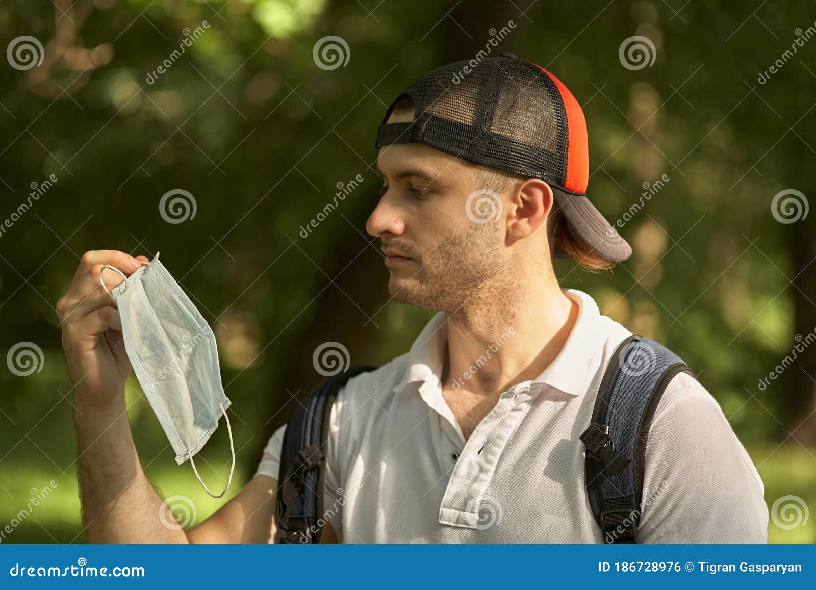 The Guy Takes Off the Mask from His Face. Walk in the Park Stock Photo ...