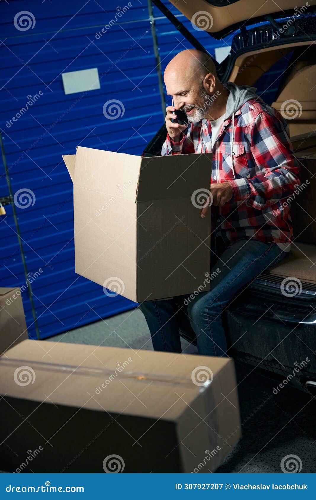 Guy Talking on the Phone Holding a Box of Things Stock Image - Image of ...
