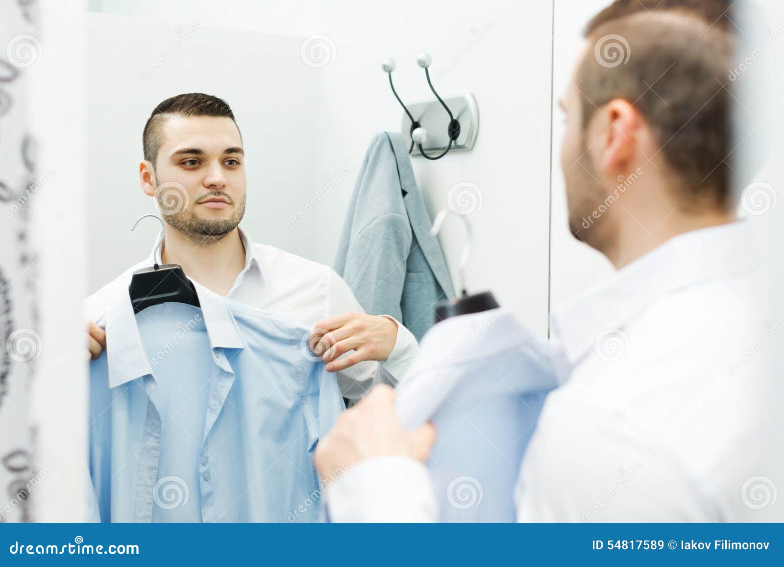Guy trying on new shirt stock image. Image of choose - 54817589