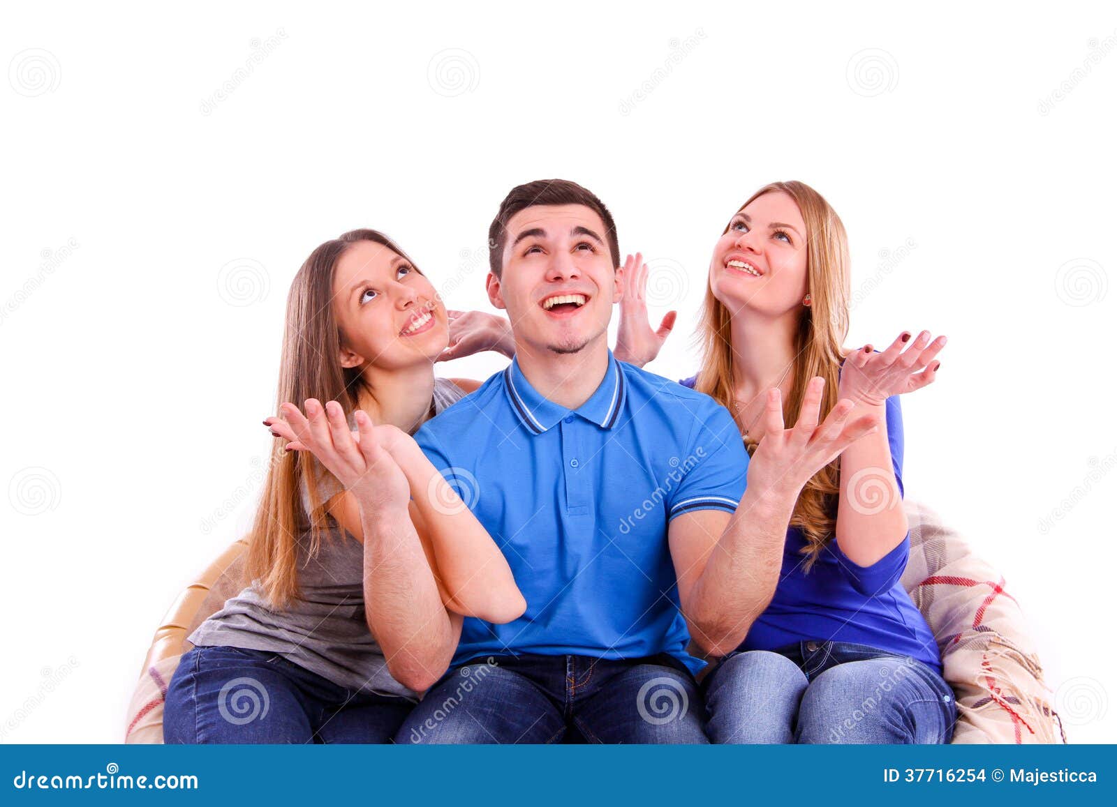 Guy and Two Girls Sitting on the Couch and Looking Up Stock Photo ...