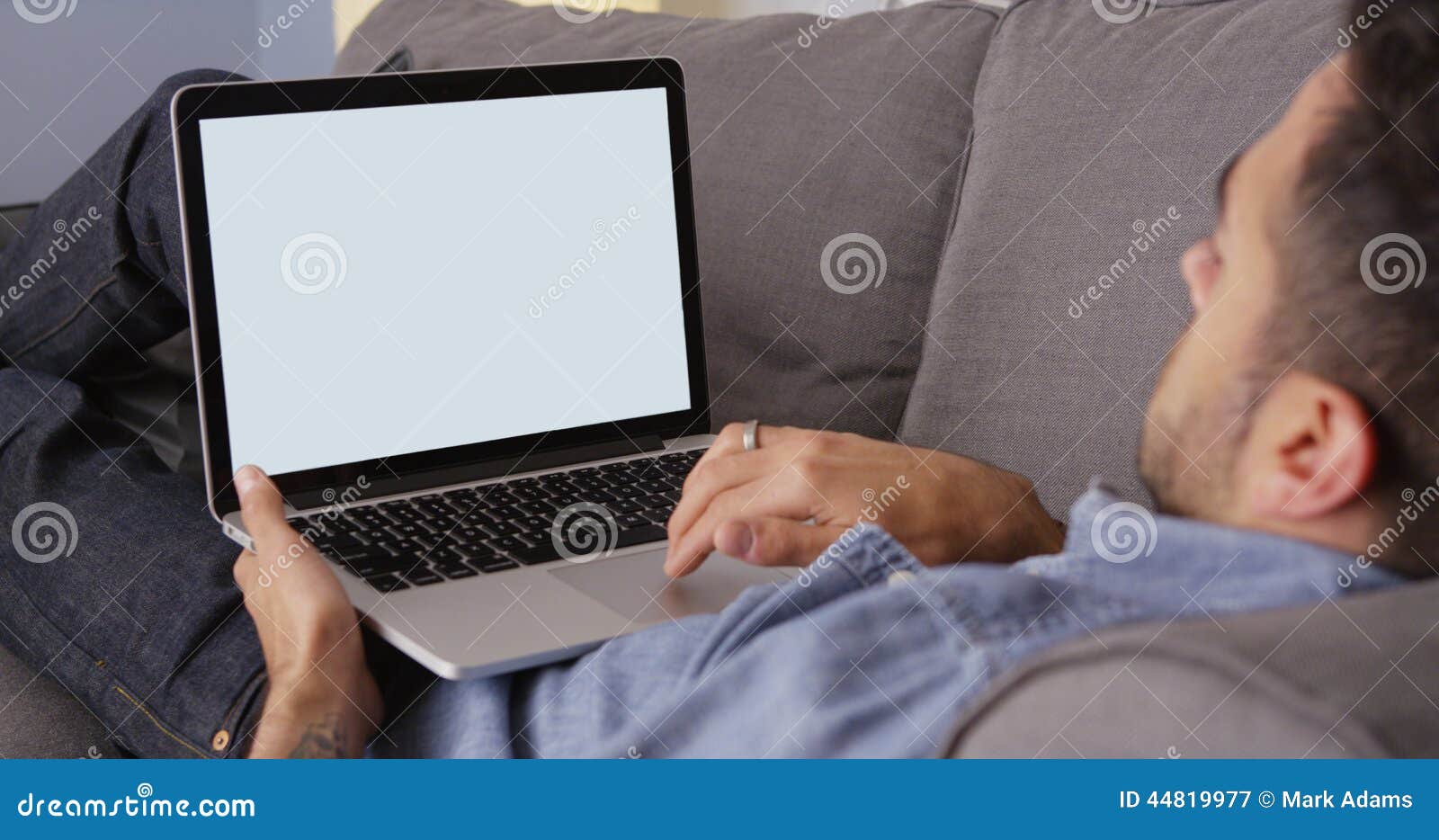 Guy using laptop on couch stock image. Image of relaxing - 44819977
