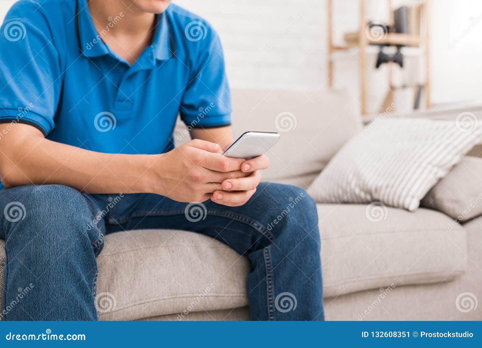 Guy Using Smartphone while Sitting on Sofa Stock Image - Image of ...