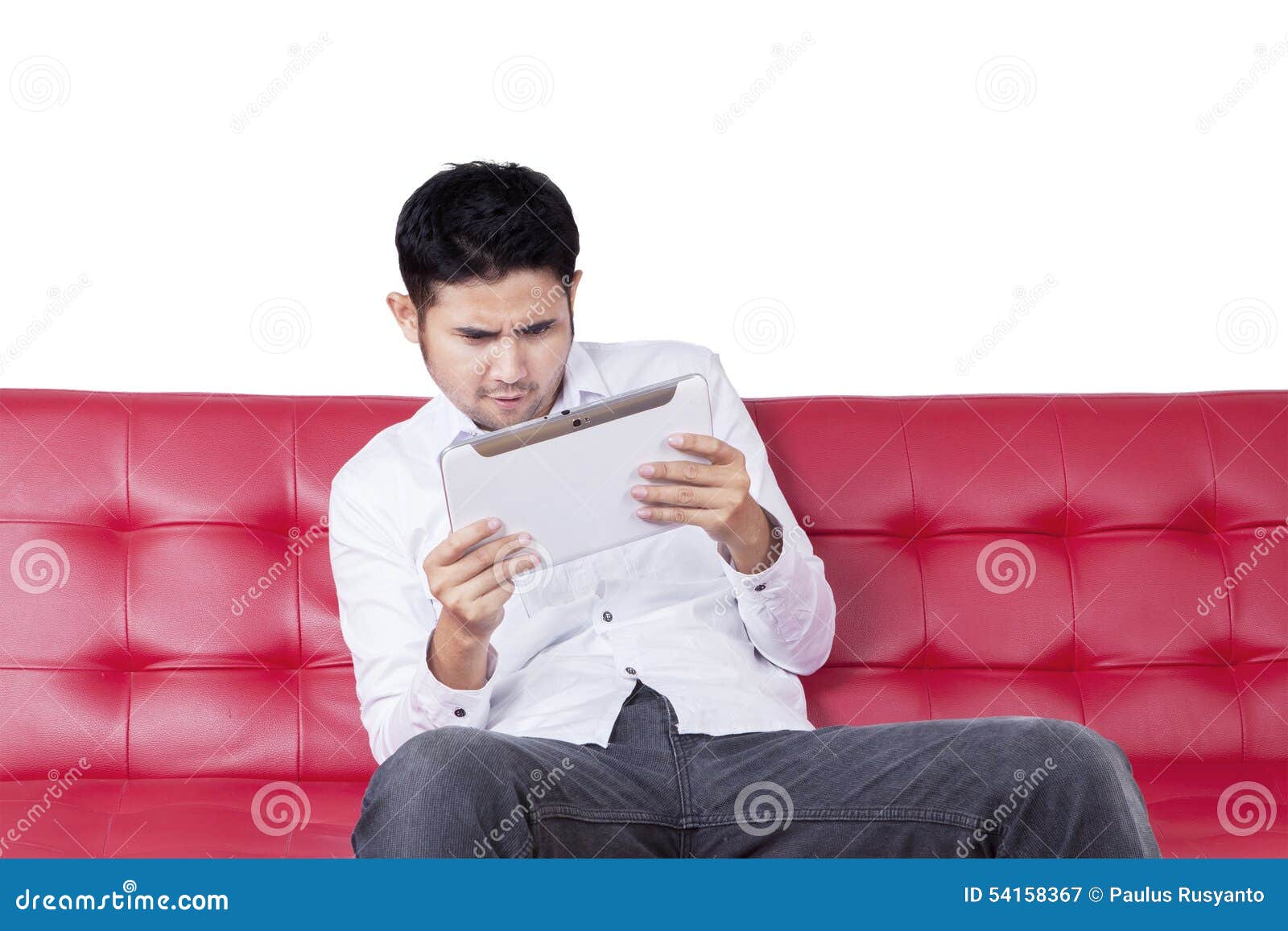 Guy using tablet on couch stock image. Image of leisure - 54158367