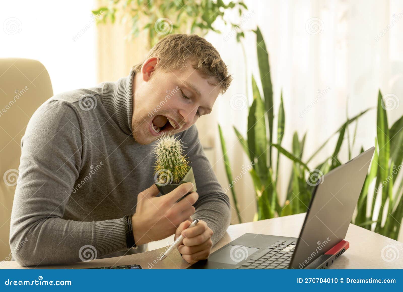 The Guy Working in the at the Computer Jokes Trying To Bite the Key ...