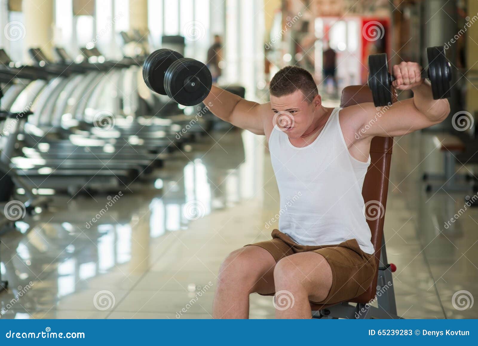 Guy working out in gym. stock image. Image of concentrated - 65239283