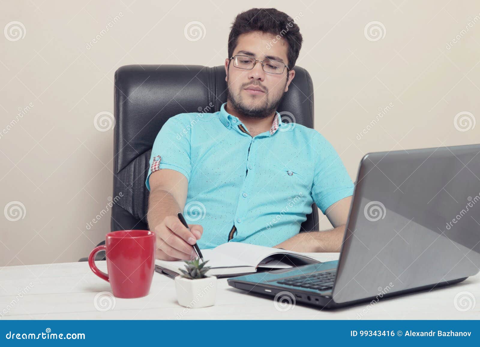 Guy writes in a notebook stock photo. Image of chair - 99343416