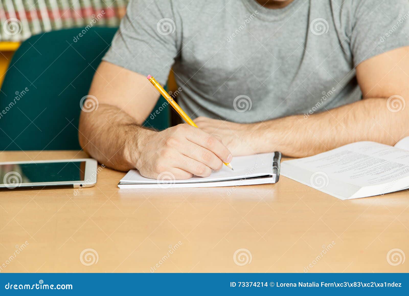 Guy writing in his desk stock photo. Image of ipad, digital - 73374214