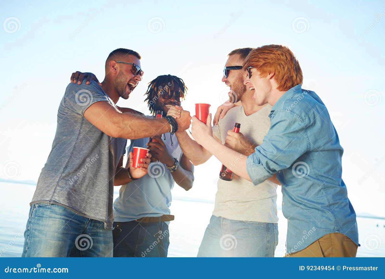 Guys on the beach stock photo. Image of restful, drink - 92349454
