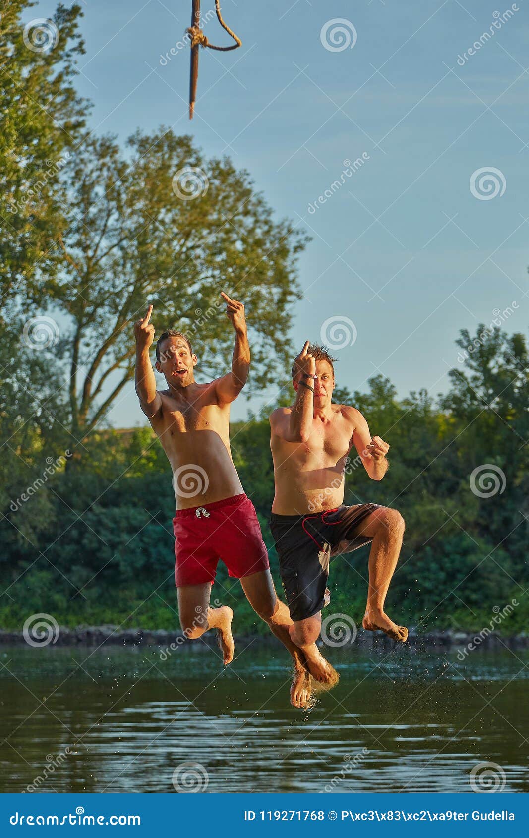 Guys jumping in a river stock photo. Image of play, camp - 119271768