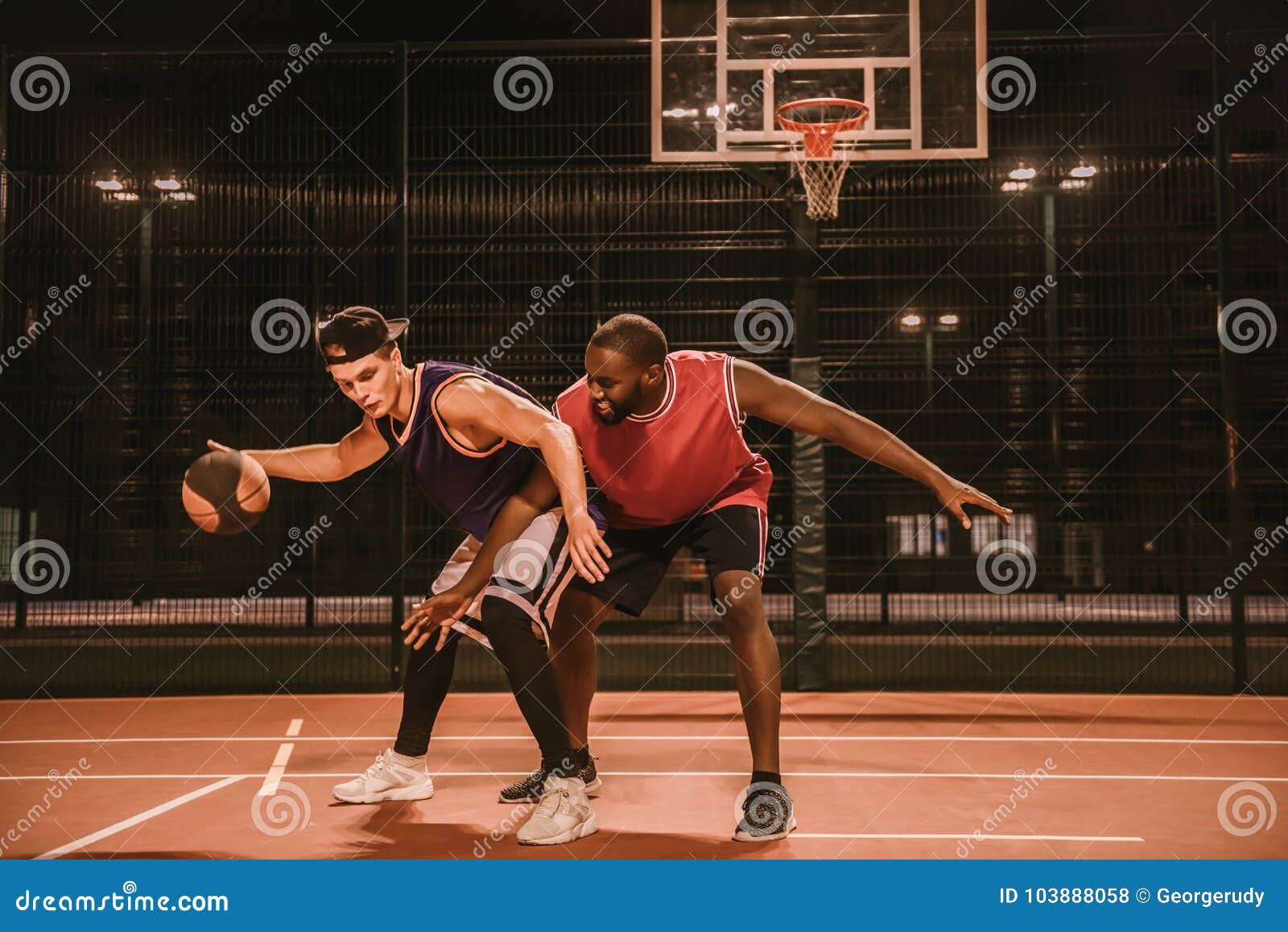 Guys playing basketball stock photo. Image of defending - 103888058