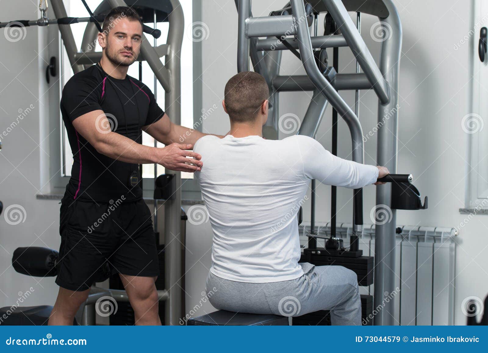 Gym Coach Helping Young Man on Back Exercise Stock Image - Image of ...