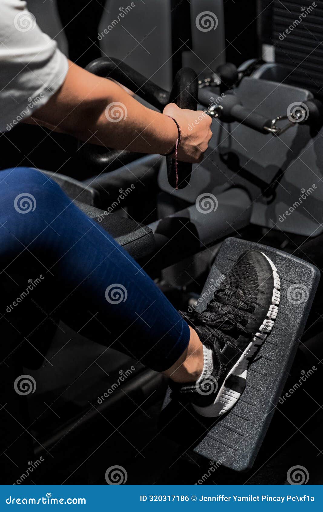 A Person is Actively Rowing on an Exercise Machine at the Gym Stock ...