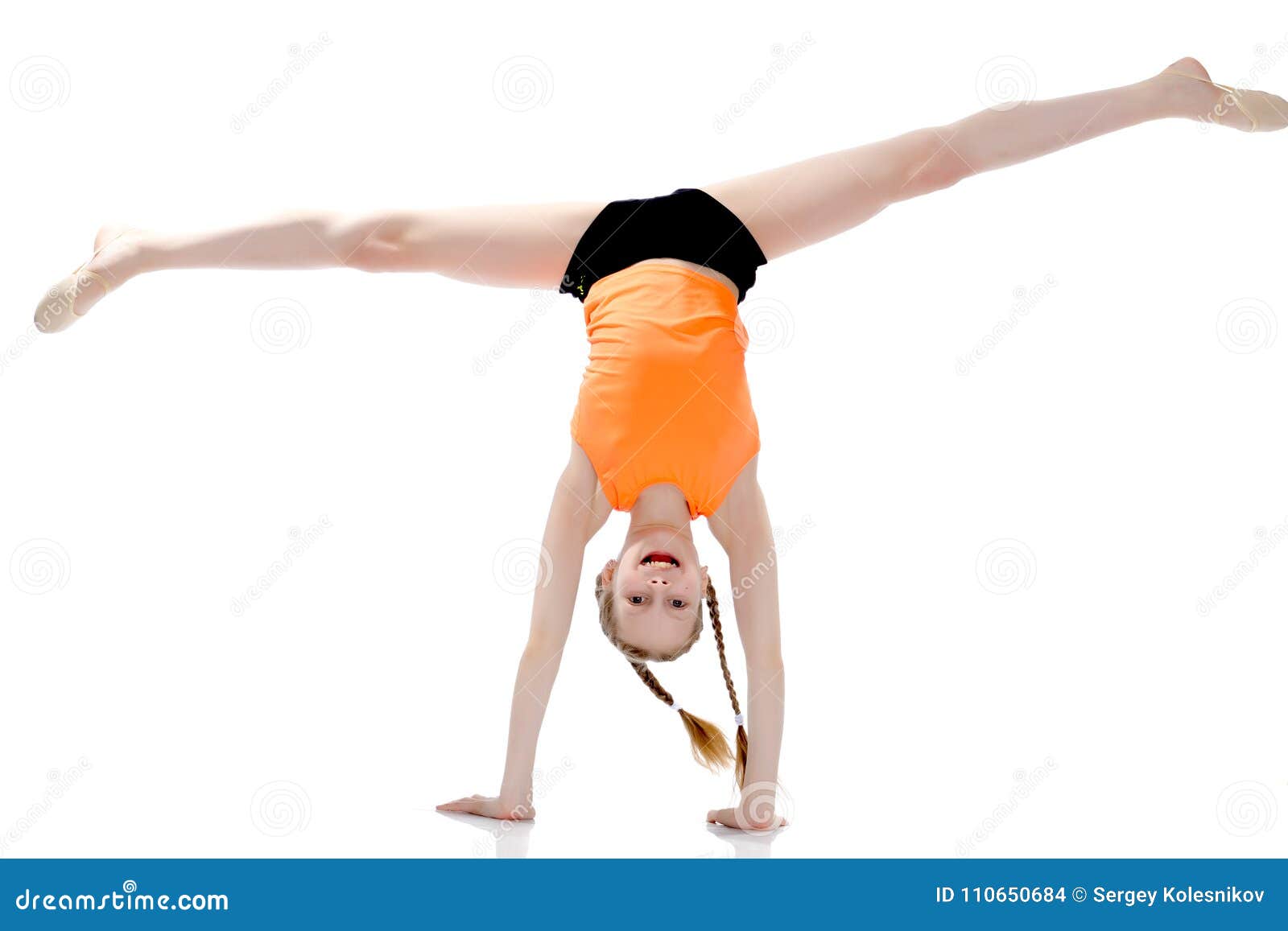 The Gymnast Performs an Acrobatic Element on the Floor. Stock Photo ...