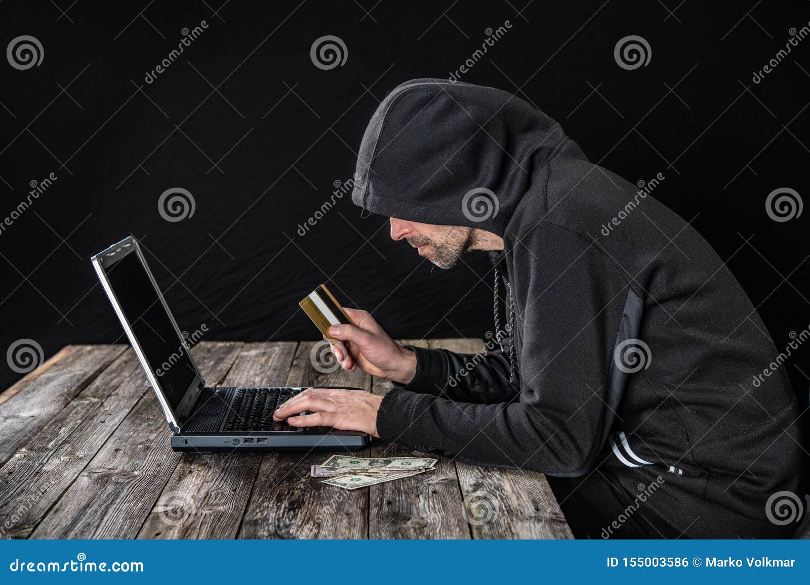 Hacker in Black Hoody with Laptop, Bank Card and Dollar Notes Stock ...