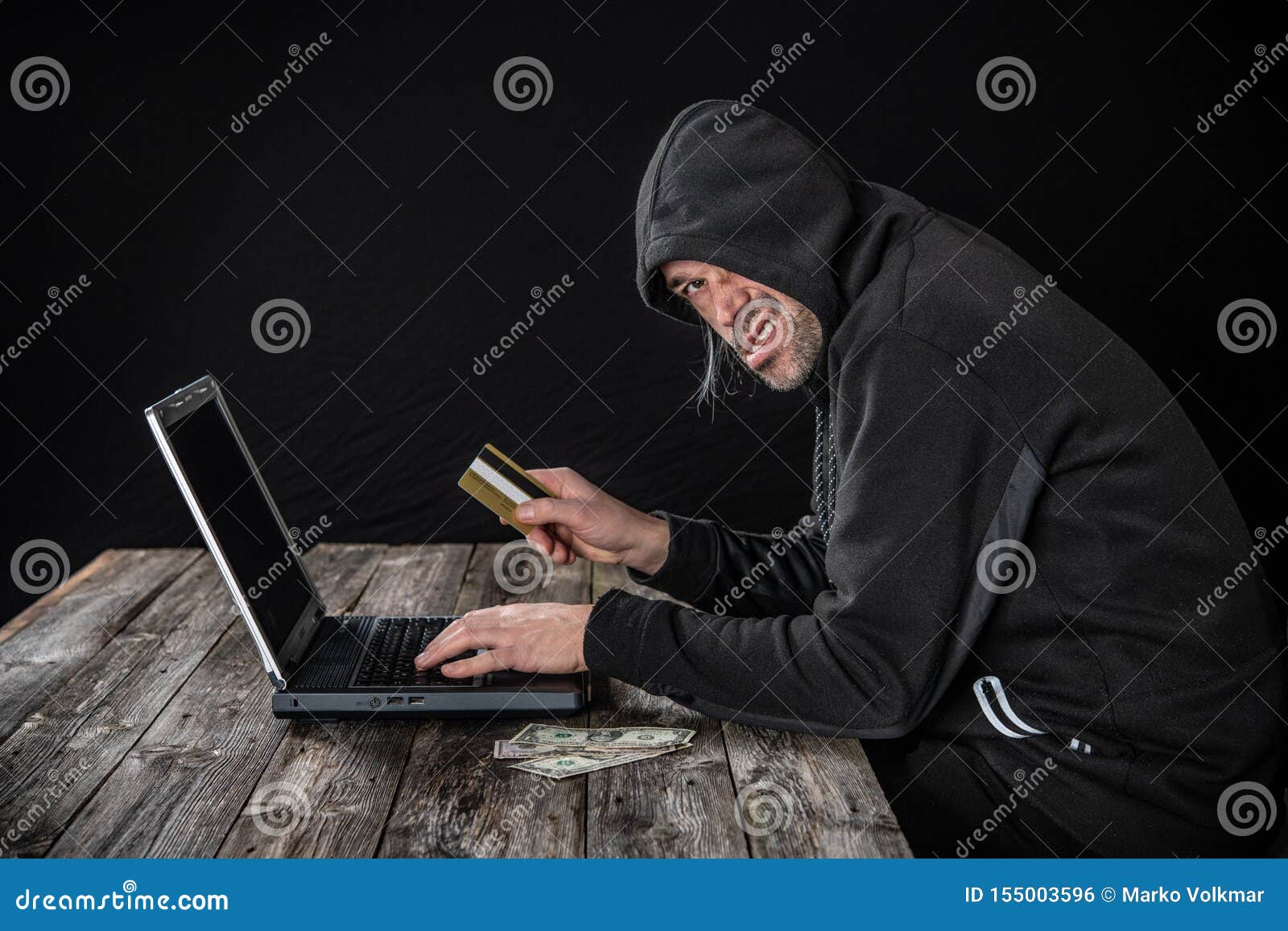 Hacker in Black Hoody with Laptop, Bank Card and Dollar Notes Stock ...