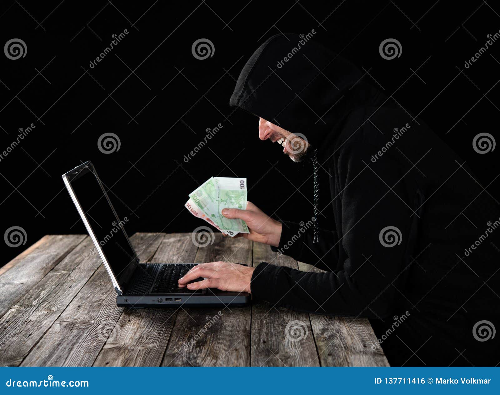 Hacker in Black Hoody with Laptop and Euro Notes Stock Photo - Image of ...