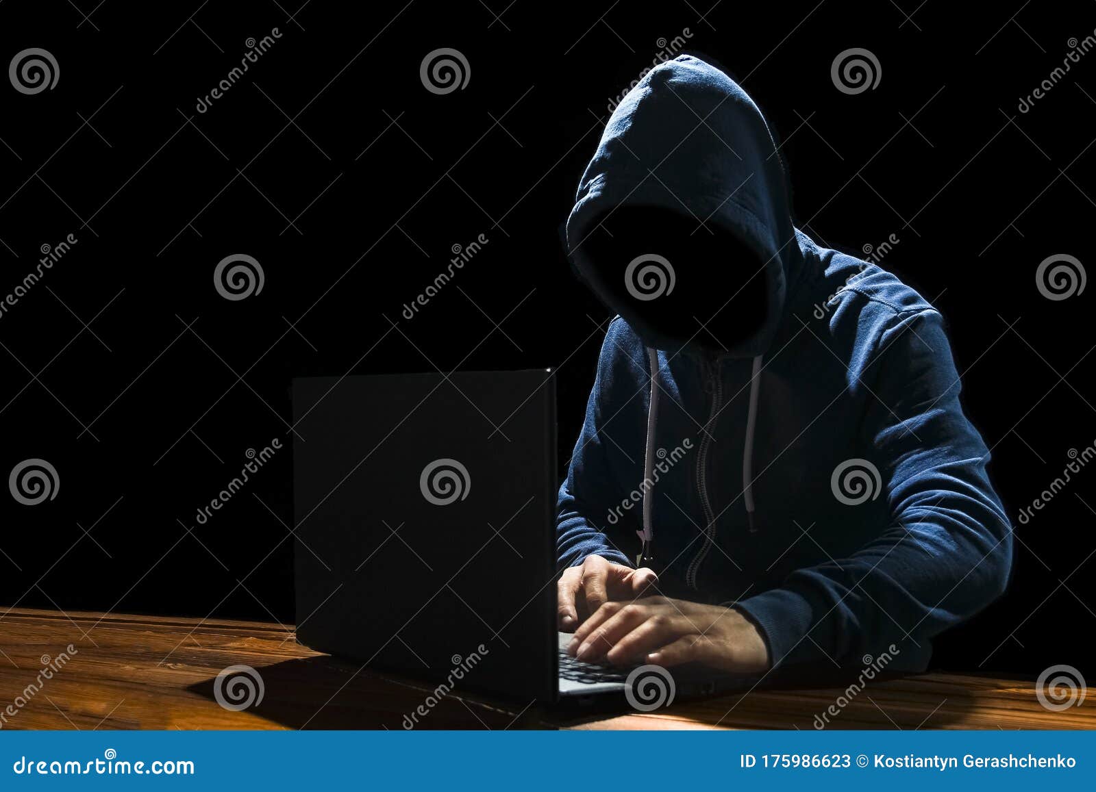 Hacker with Computer Man Sitting at a Table in a Hood Stock Image ...