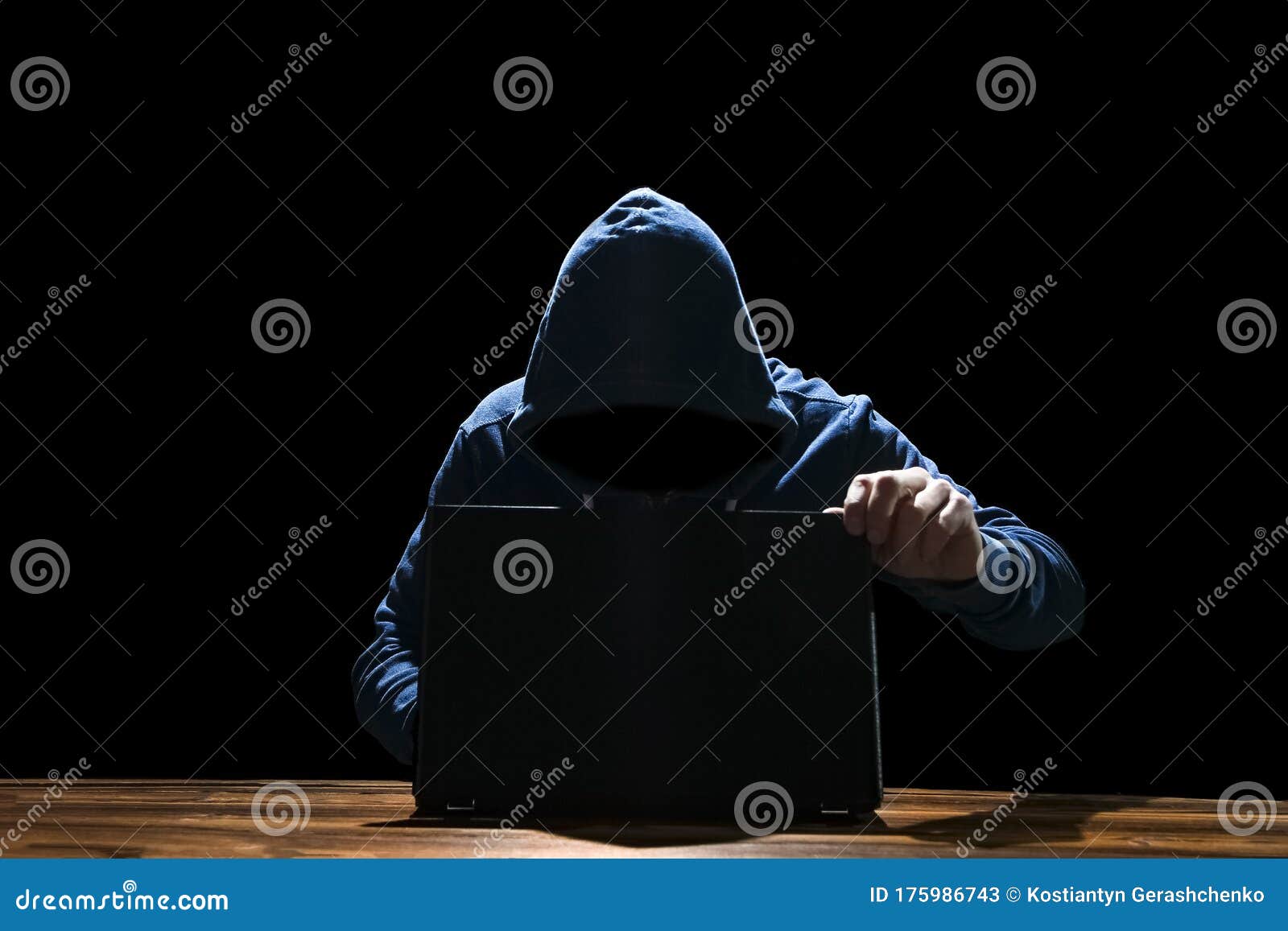 Hacker with Computer Man Sitting at a Table in a Hood Stock Image ...