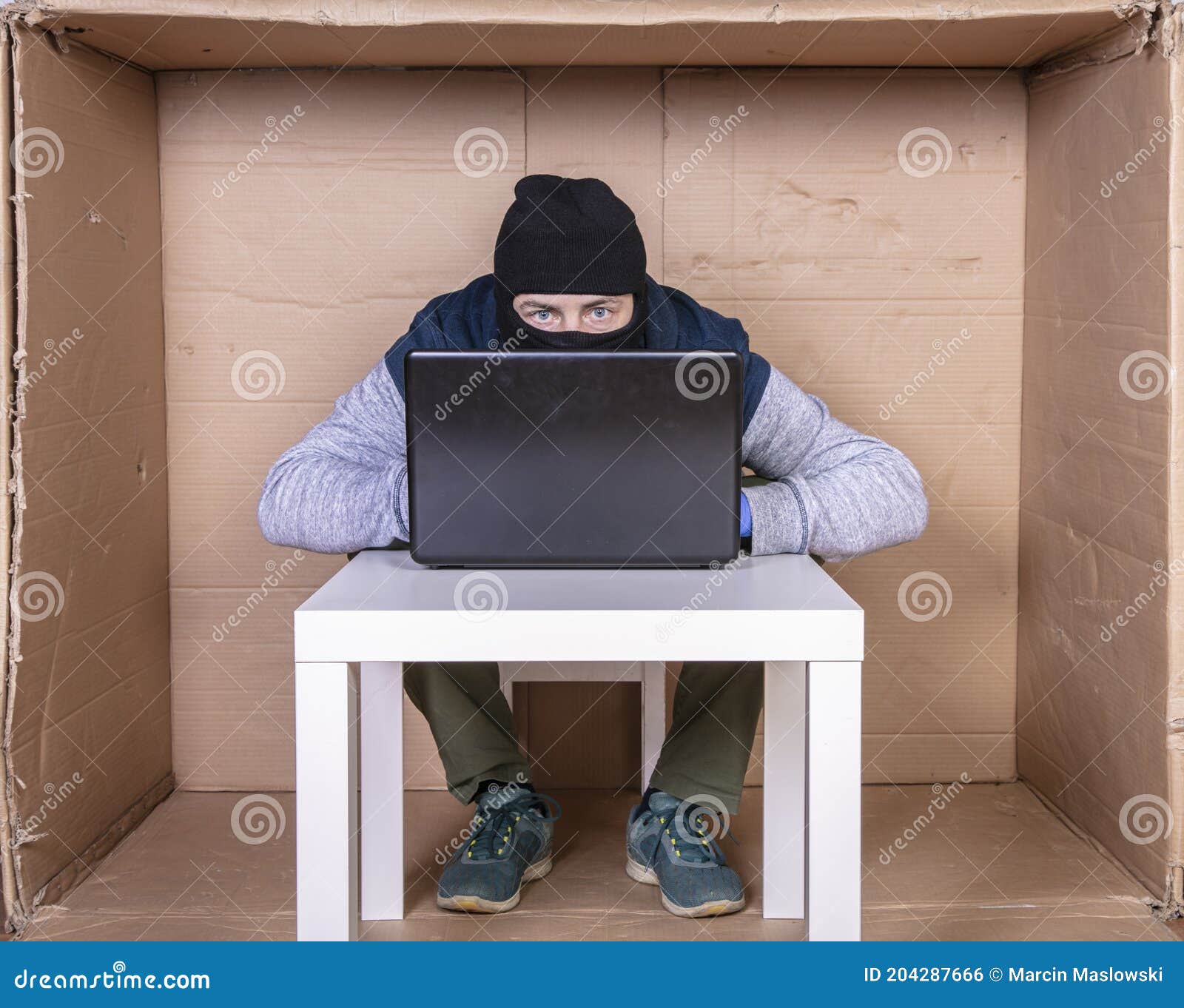Hacker Covers His Face while Working on a Computer Stock Photo - Image ...