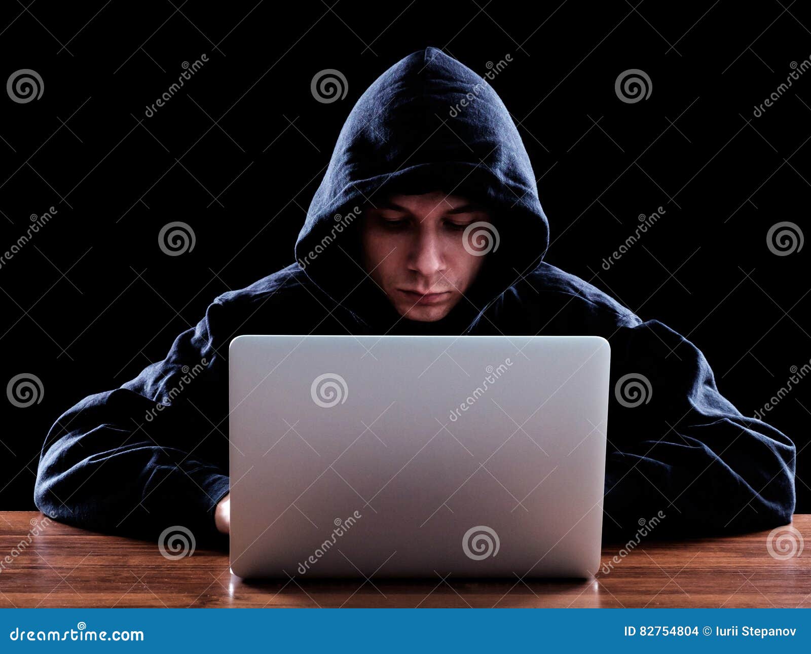 Hacker in a Dark Hoody Sitting in Front of a Notebook Stock Photo ...