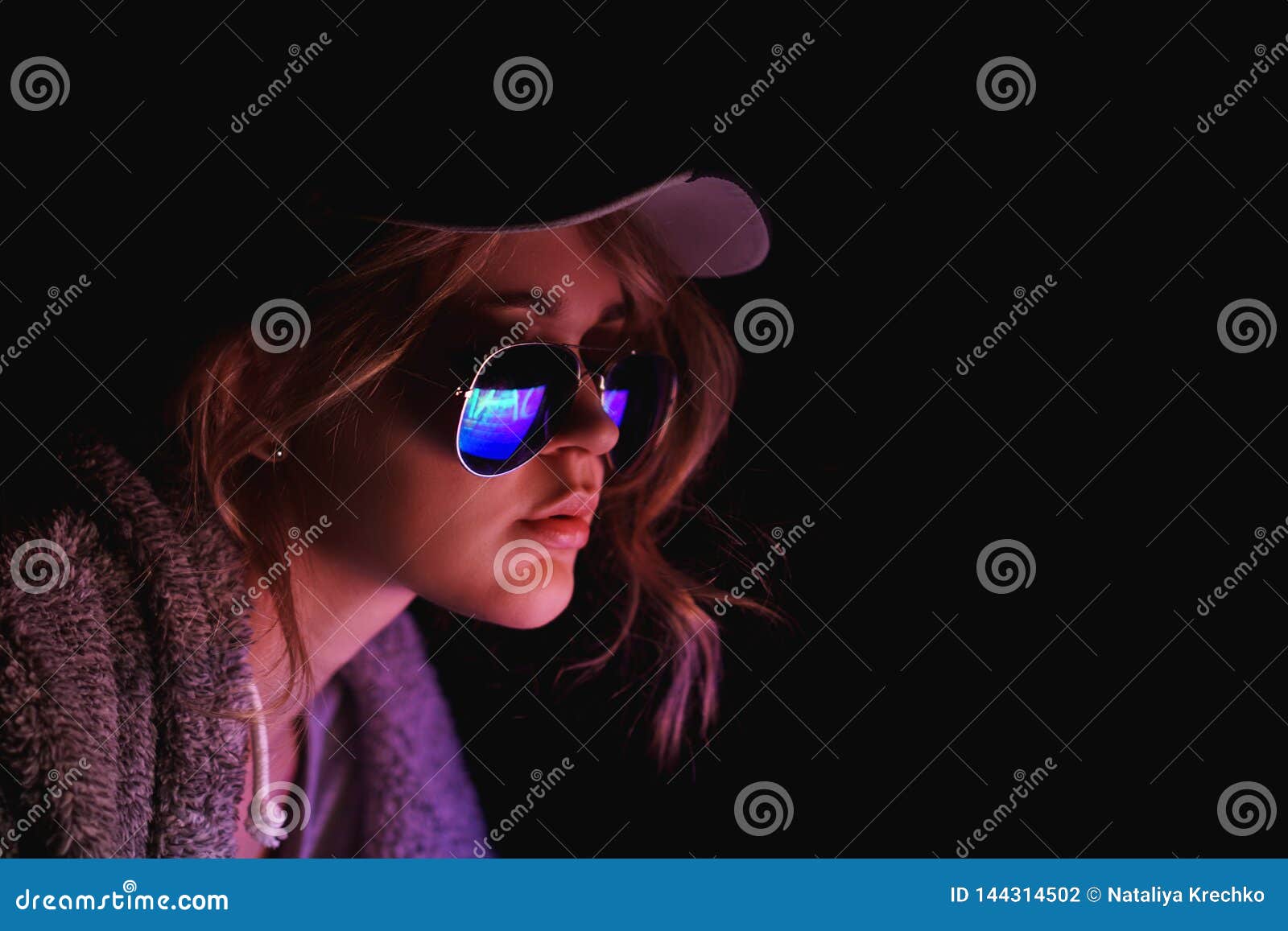 Hacker Girl in Cap and Sunglasses in Front of a Computer in Neon Light ...