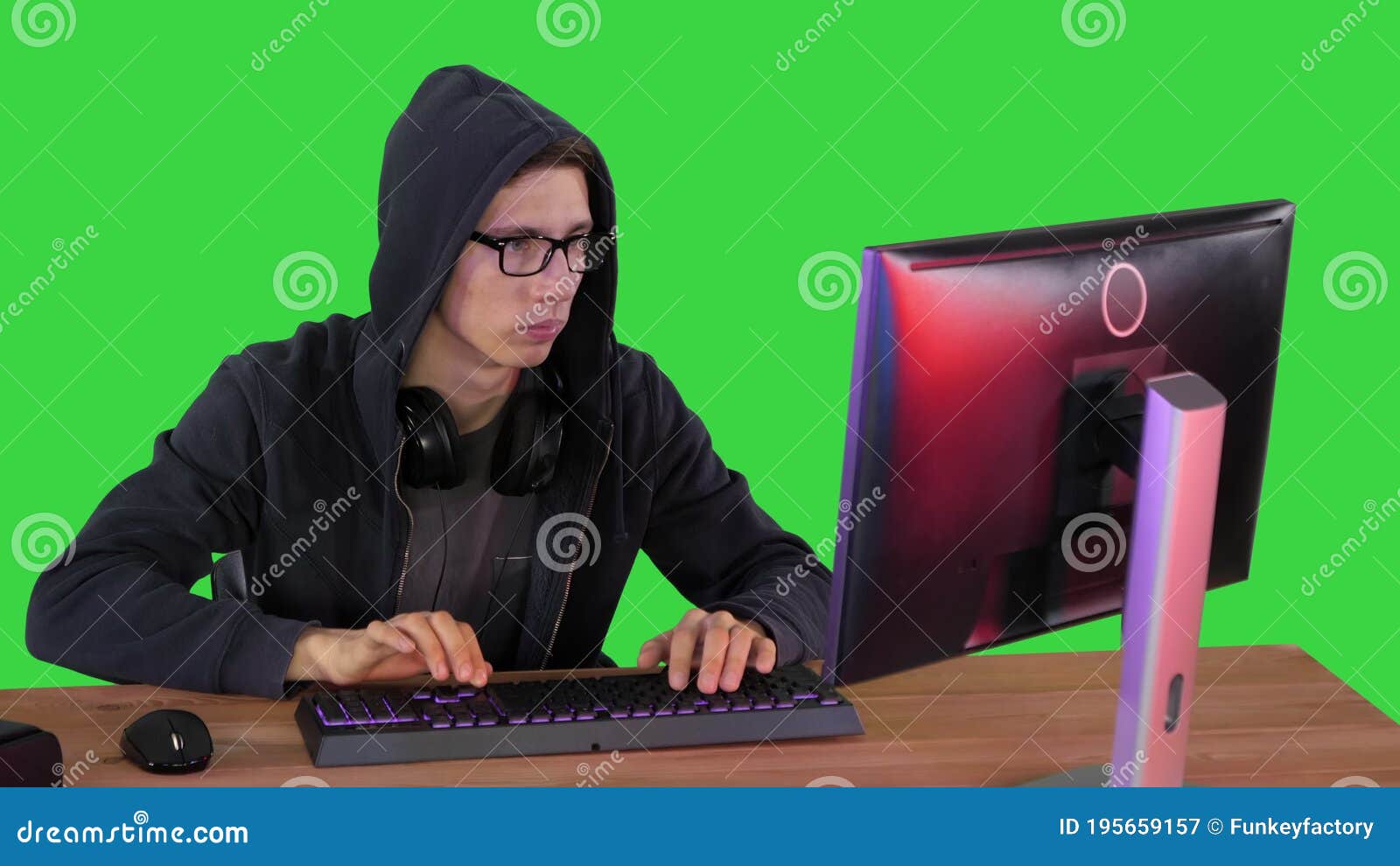 Hacker in Glasses Breaking Code on a Green Screen, Chroma Key. Stock ...