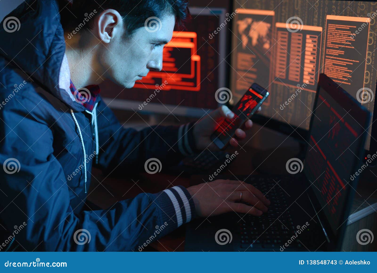 Hacker Holding the Phone in His Hands Trying To Hack the Mobile Device ...