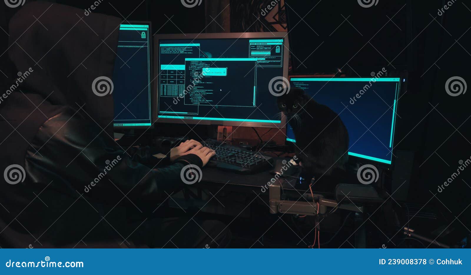 Hacker in a Hood Sits in Front of Computer Screens and Hacks Databases ...