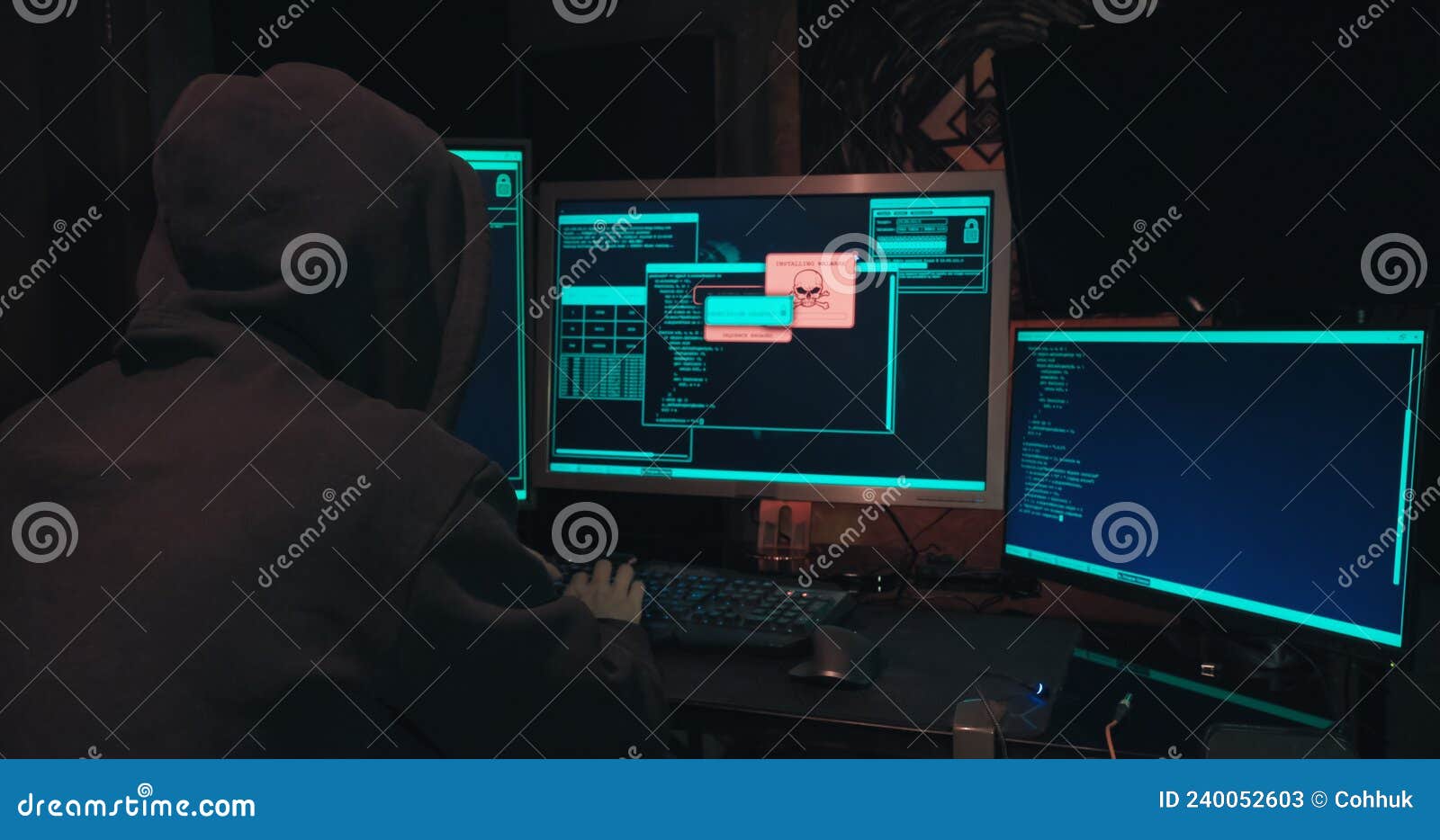 Hacker in a Hood Sits in Front of Computer Screens and Hacks Databases ...