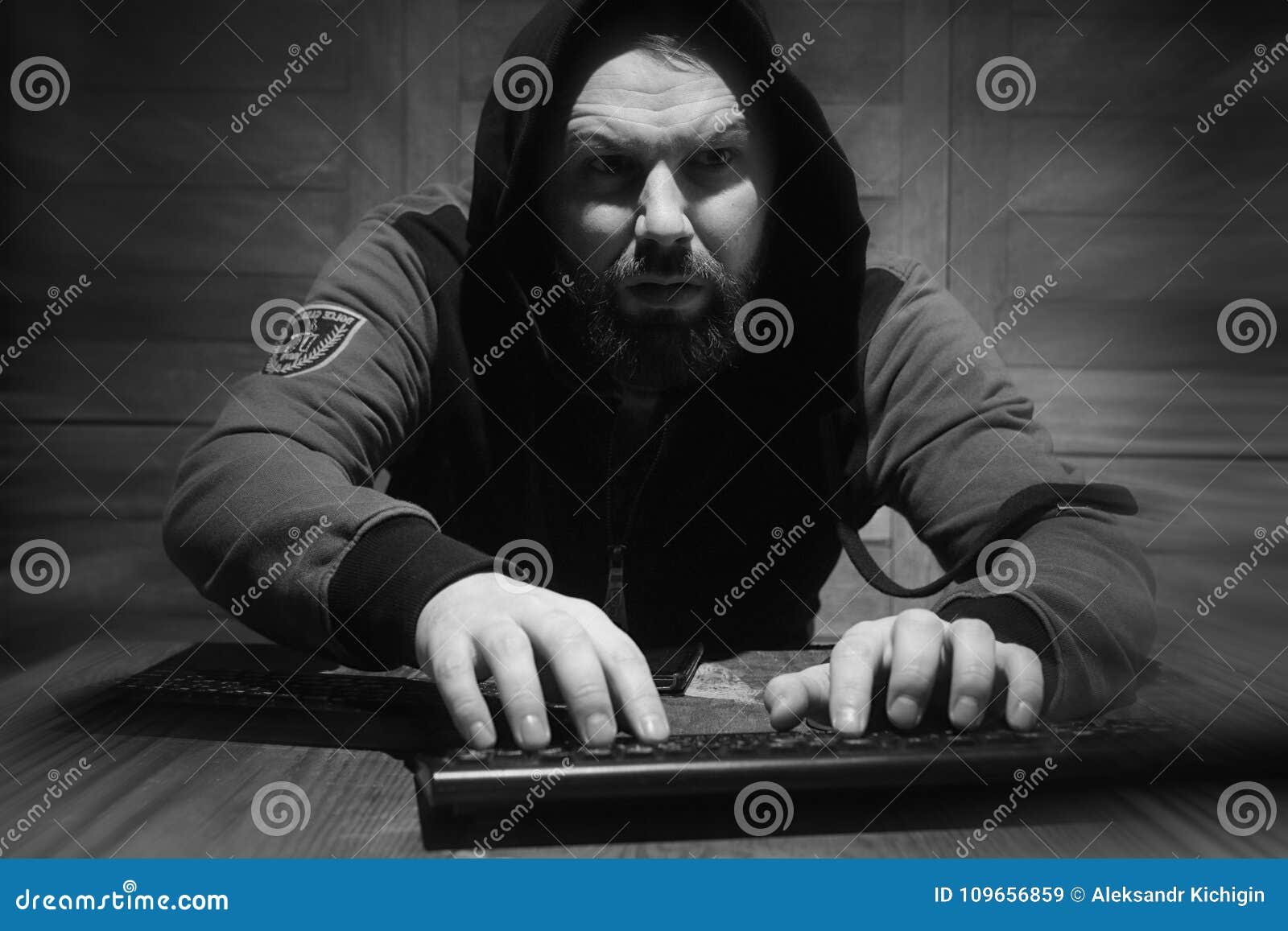 The Hacker in the Hood Sits and Works Behind the Computer Stock Image ...