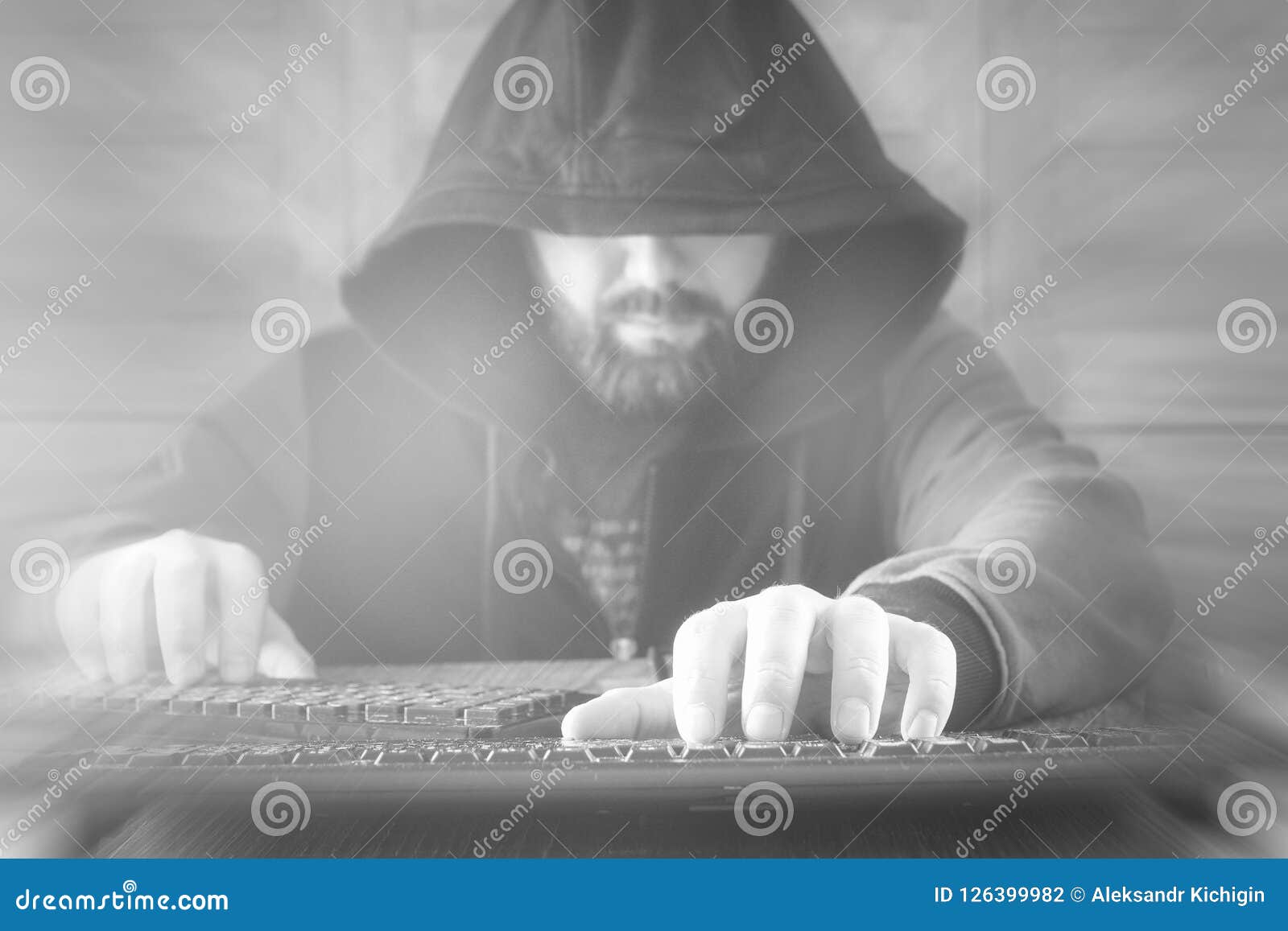 The Hacker in the Hood Sits and Works Behind the Computer Stock Photo ...