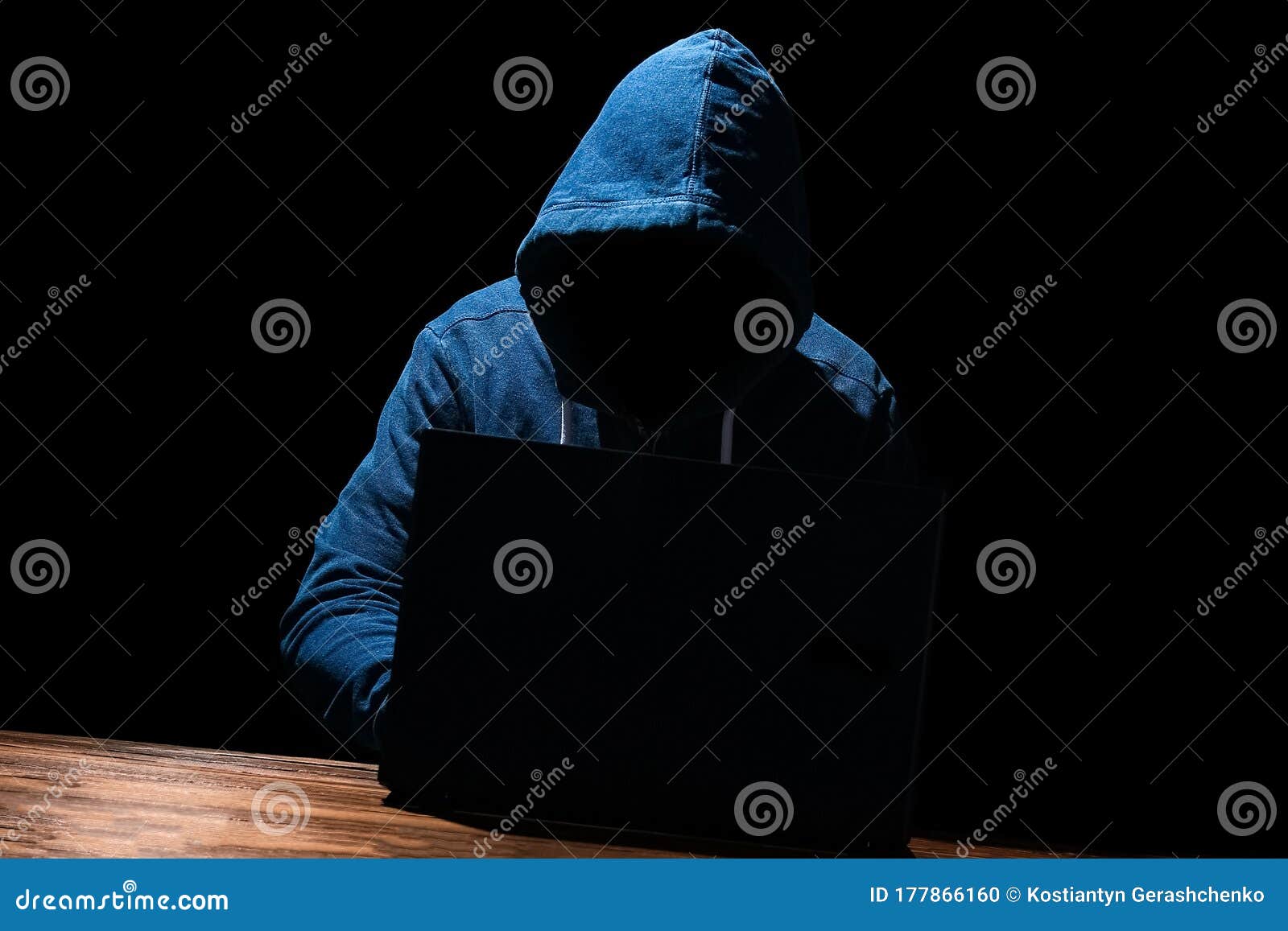 A Hacker with Laptop Sits at a Table and Abstract Binary Code. Business ...