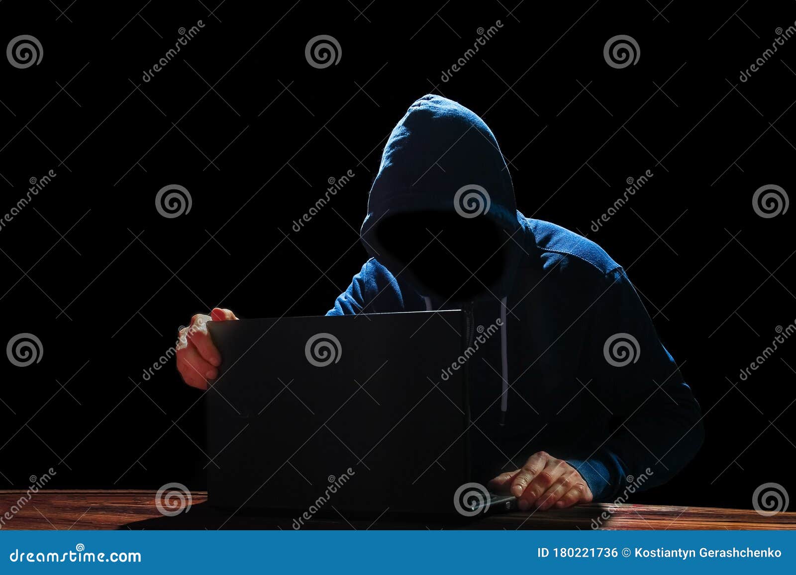 A Hacker with Laptop Sits at a Table and Abstract Binary Code. Business ...
