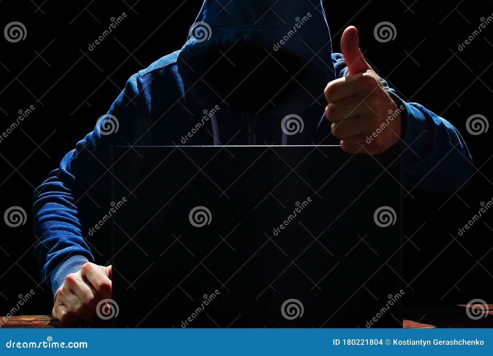 A Hacker with Laptop Sits at a Table and Abstract Binary Code. Business ...