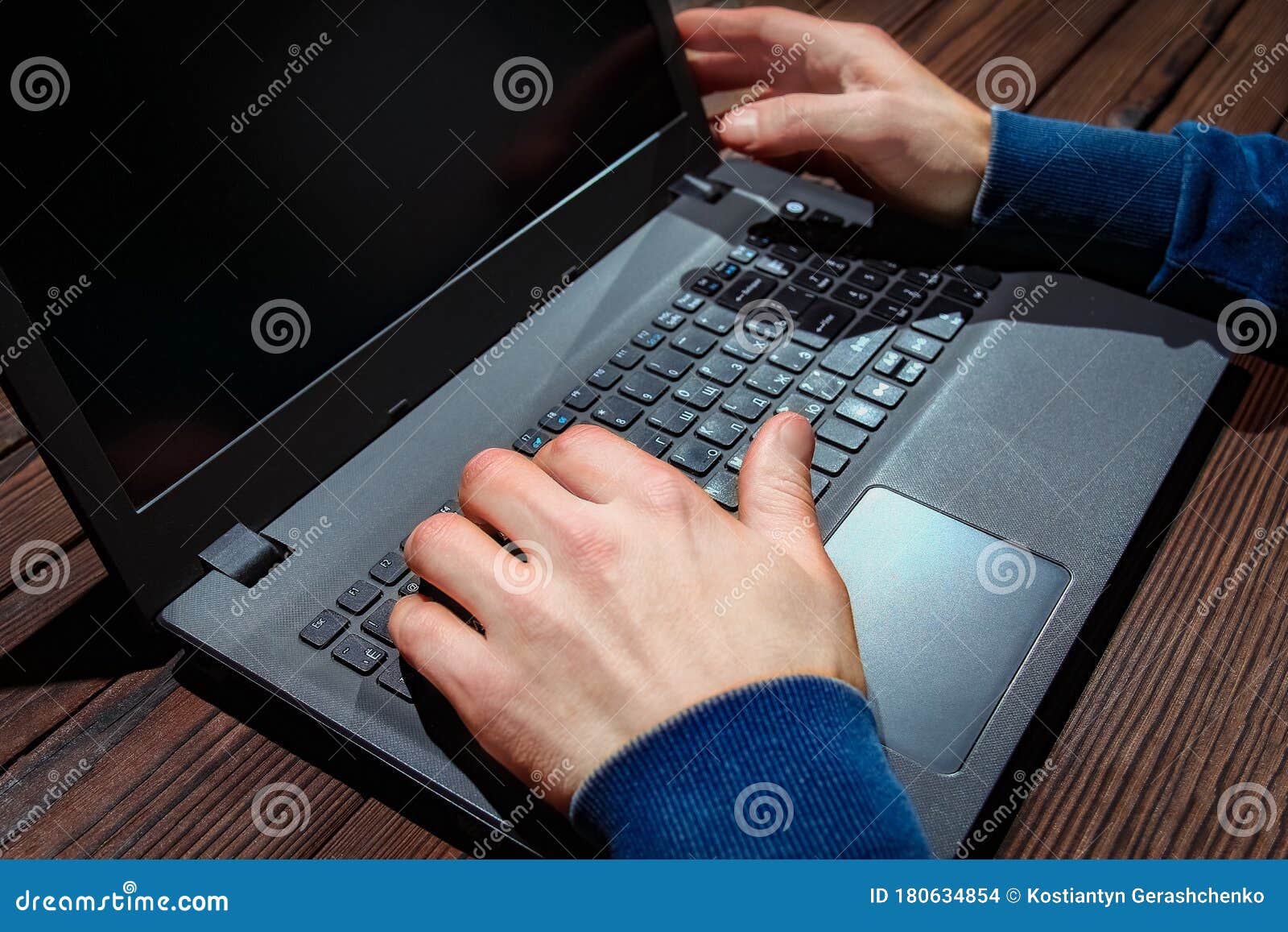 A Hacker with Laptop Sits at a Table and Abstract Binary Code. Business ...