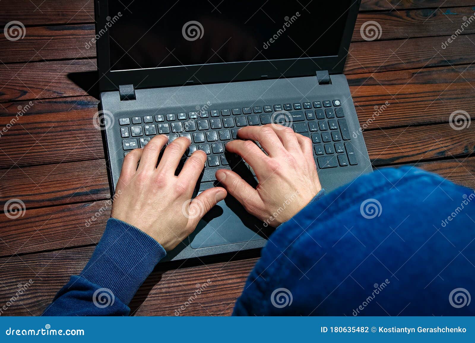 A Hacker with Laptop Sits at a Table and Abstract Binary Code. Business ...