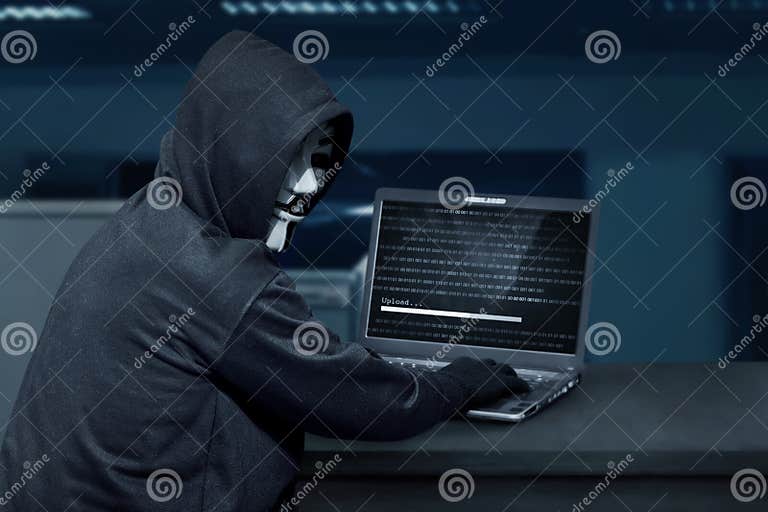 Hacker Man Wearing Mask Using Laptop To Upload Computer Virus Editorial ...